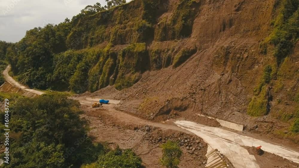 Landslides and rockfalls on the road in the mountains.Aerial view: mud ...