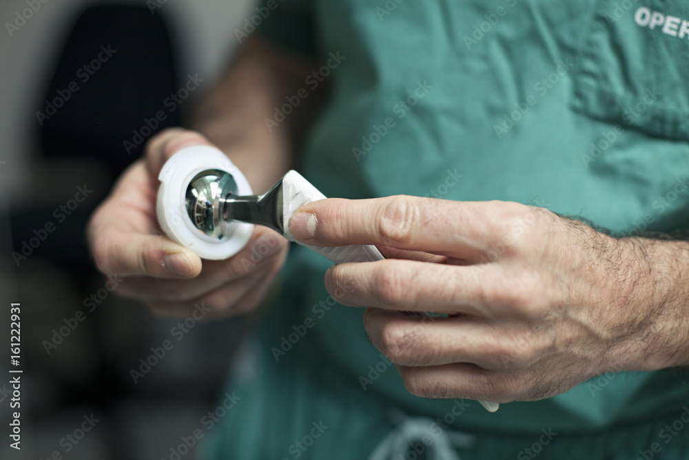 Surgeon holding a parts of hip prosthesis Stock Photo | Adobe Stock