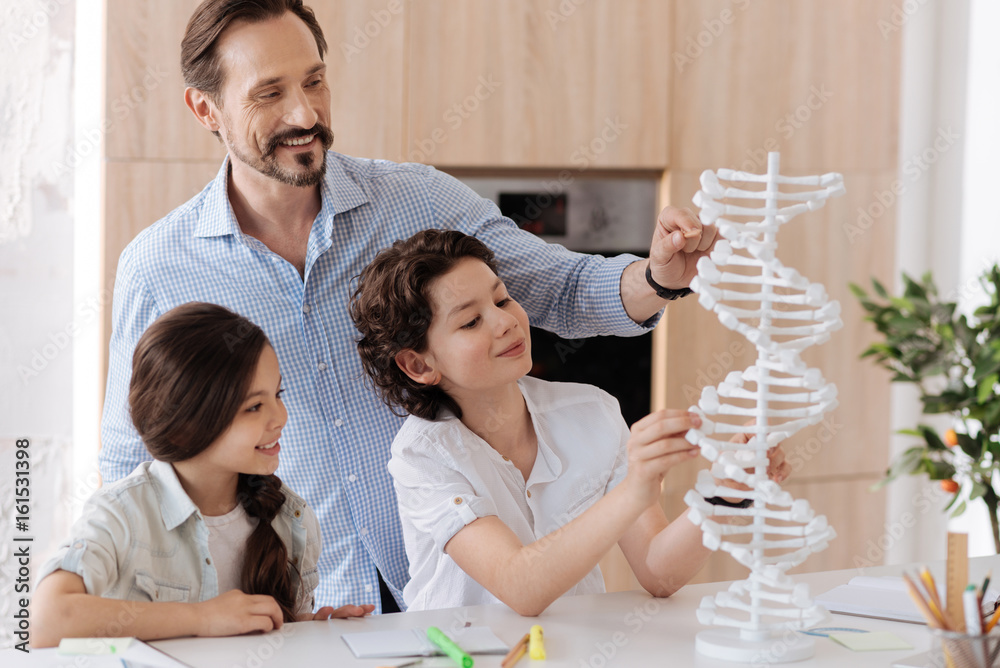 Father and his children studying a 3D DNA model Stock Photo | Adobe Stock