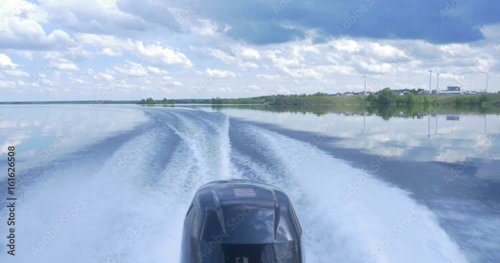 Trail on water surface behind of fast moving motor boat. the motor of ...