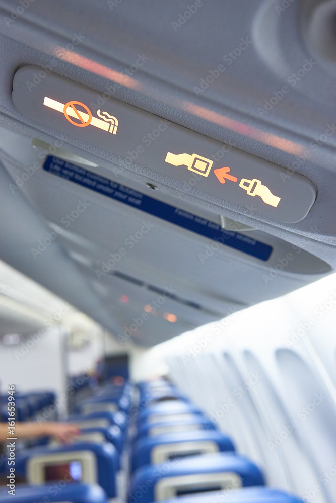Foto de Security on a plane / Fasten Seat belt sign and No Smoking sign ...