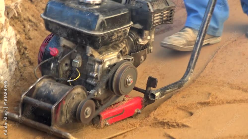 Ramming mechanism for sand and soil. Manual compaction of earth work ...