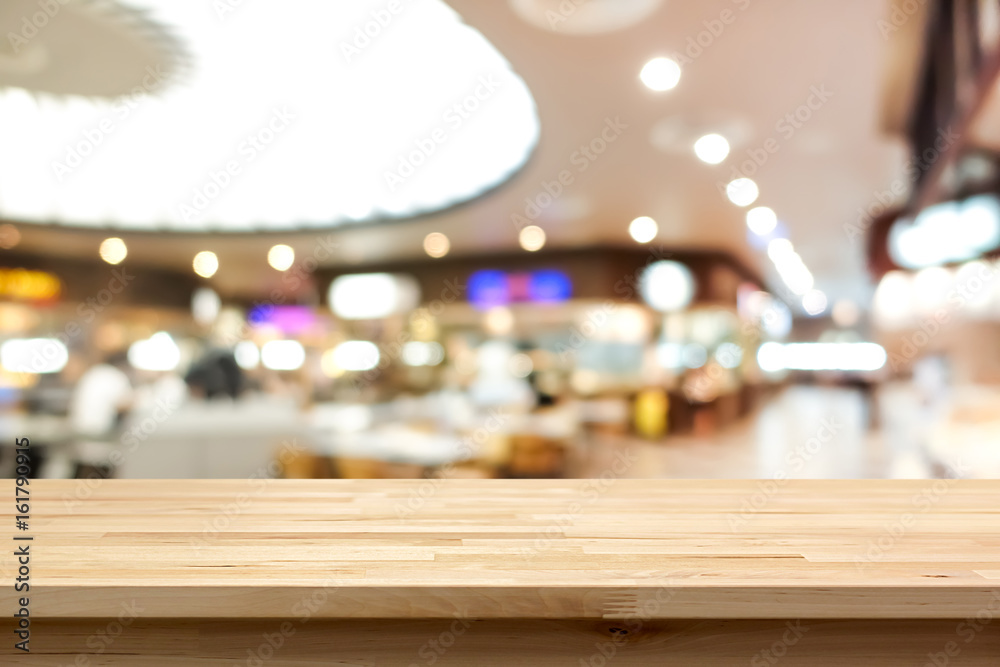 Wood table top on blur background of food court in shopping mall Stock ...