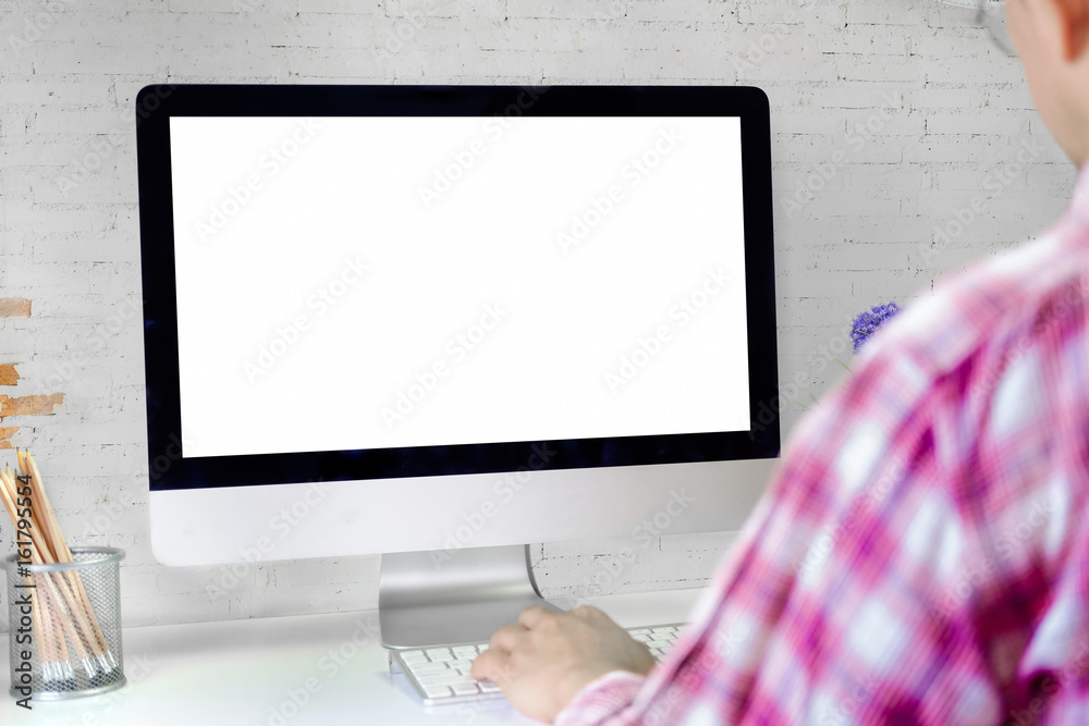 Businessman using a desktop computer with a view over his shoulder from ...