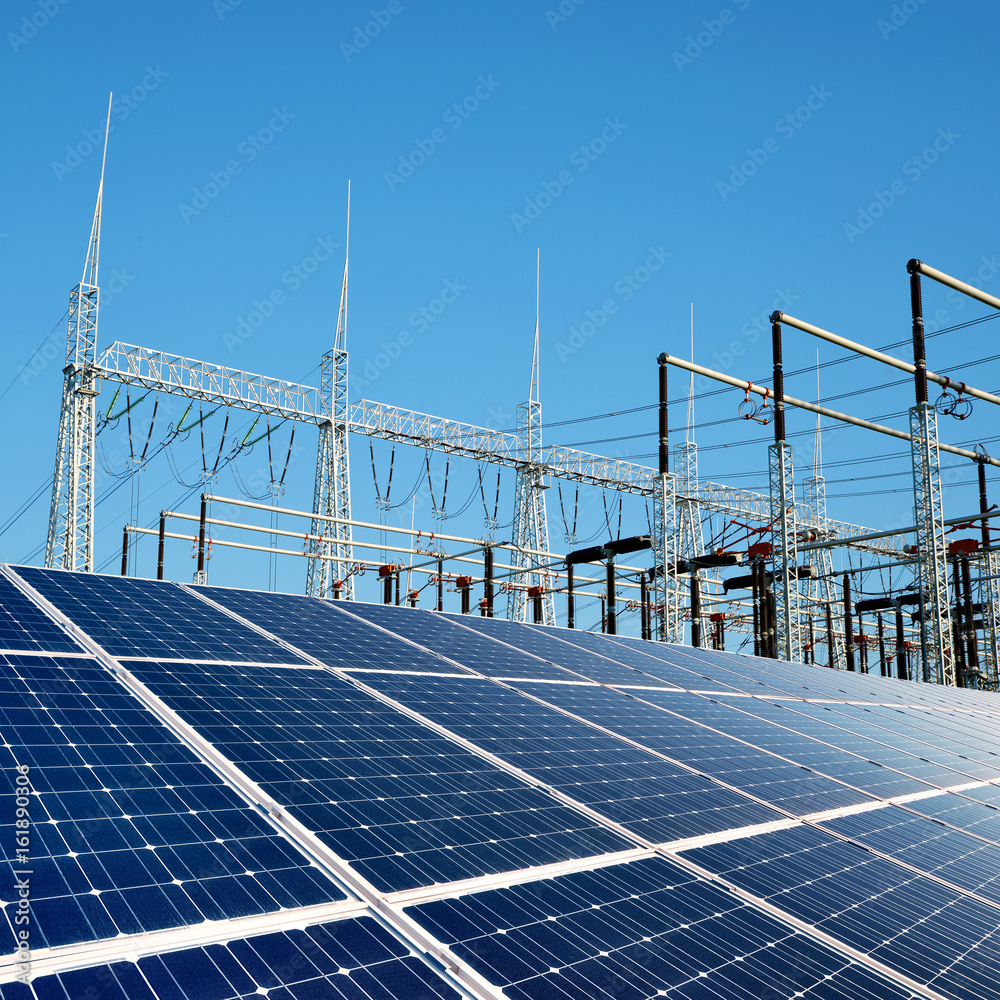 Solar energy panels in the background high voltage power substation ...