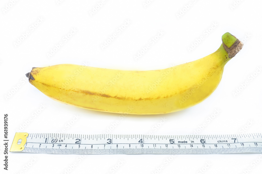 Measuring tape wrapped around a banana, isolated on a white background ...