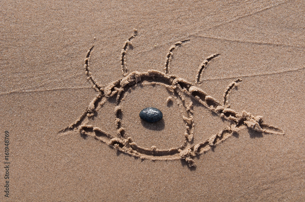 eye drawn in the sand. Beach background. Top view Stock Photo | Adobe Stock