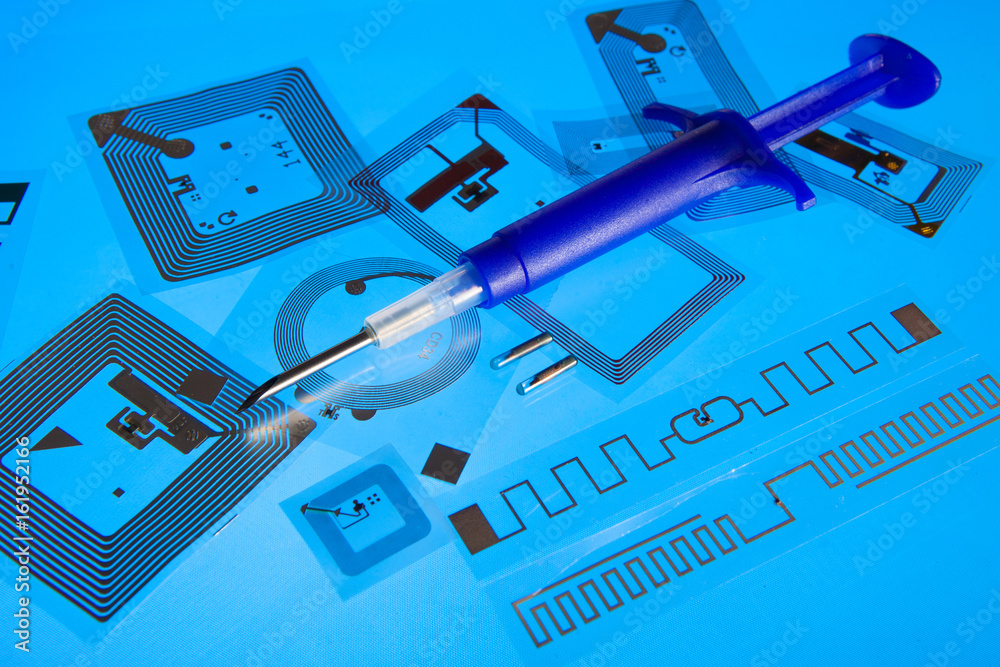 RFID implantation syringe and chips on RFID tags (Radio Frequency ...