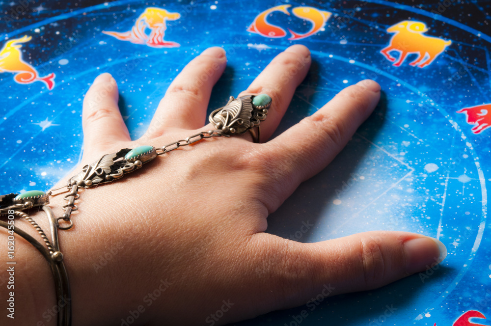 astrologer fortune teller hand over esoteric background with zodiac ...