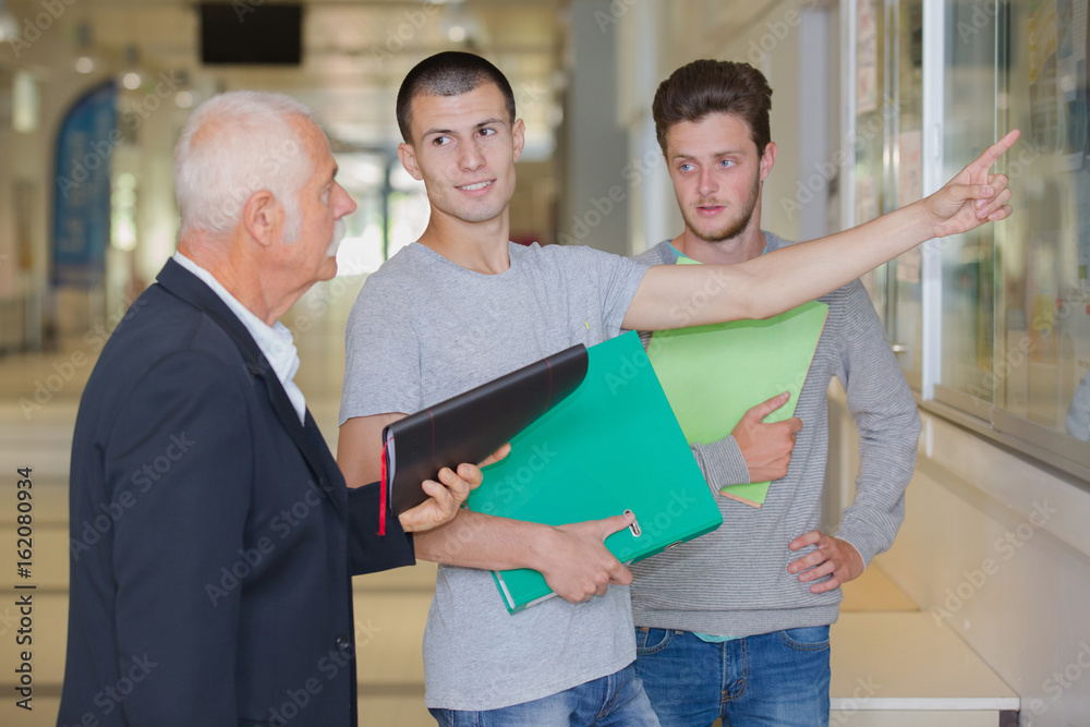 students asking teacher where it is the classroom Stock Photo | Adobe Stock