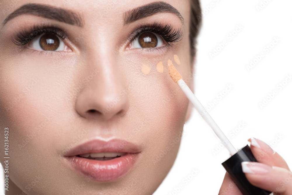 Attractive girl covering her face with decorative cosmetic Stock Photo ...