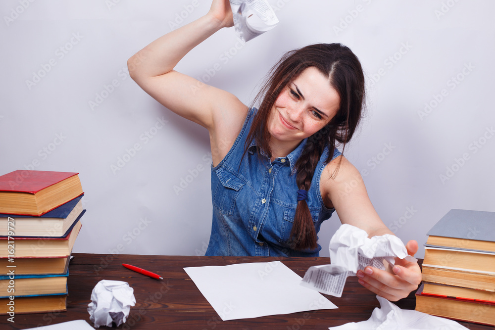 Student girl crumpling sheets of paper. Young stressed furious woman ...