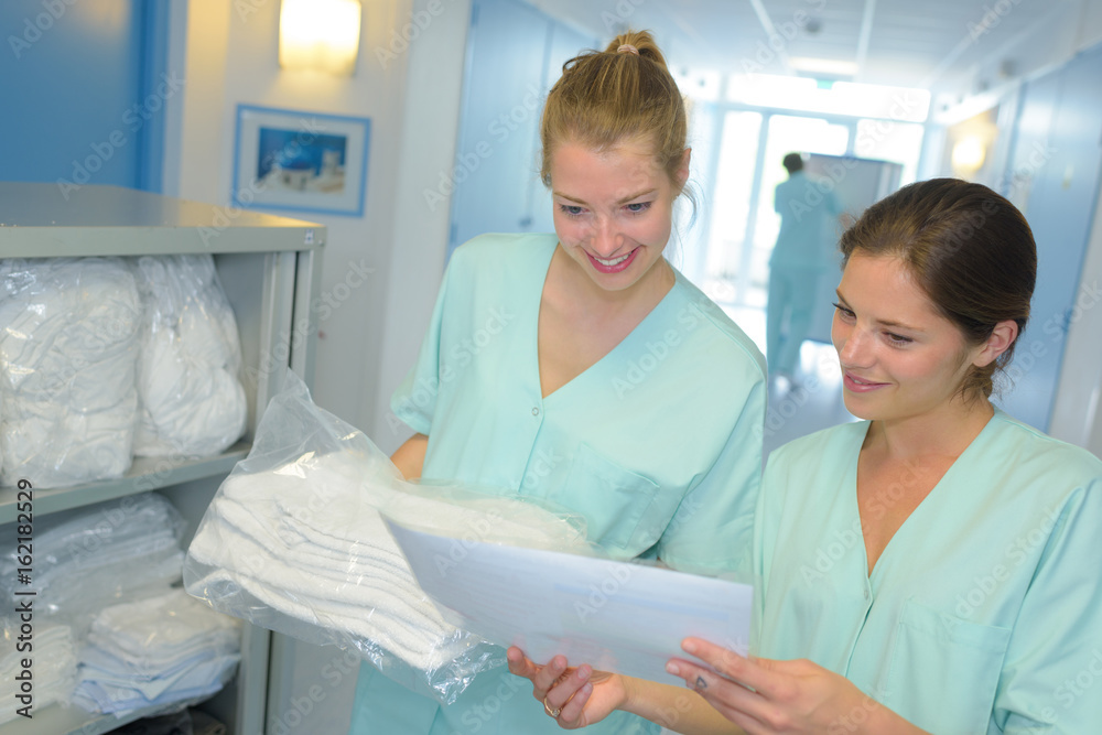 portrait of 2 nurses checking laundry list at the hospital Stock Photo ...