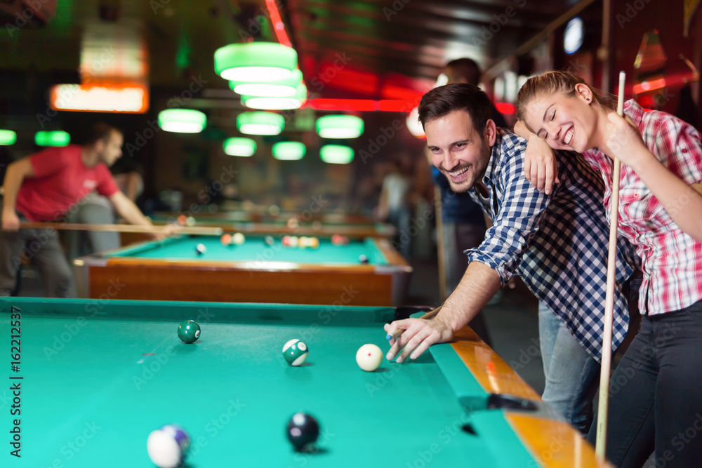 Young couple playing together pool in bar Stock Photo | Adobe Stock