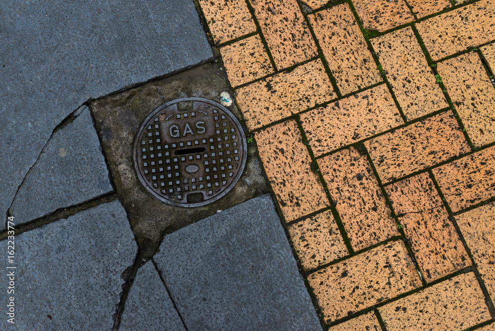 Manhole cover for Natural gas utility access on the street Stock Photo ...