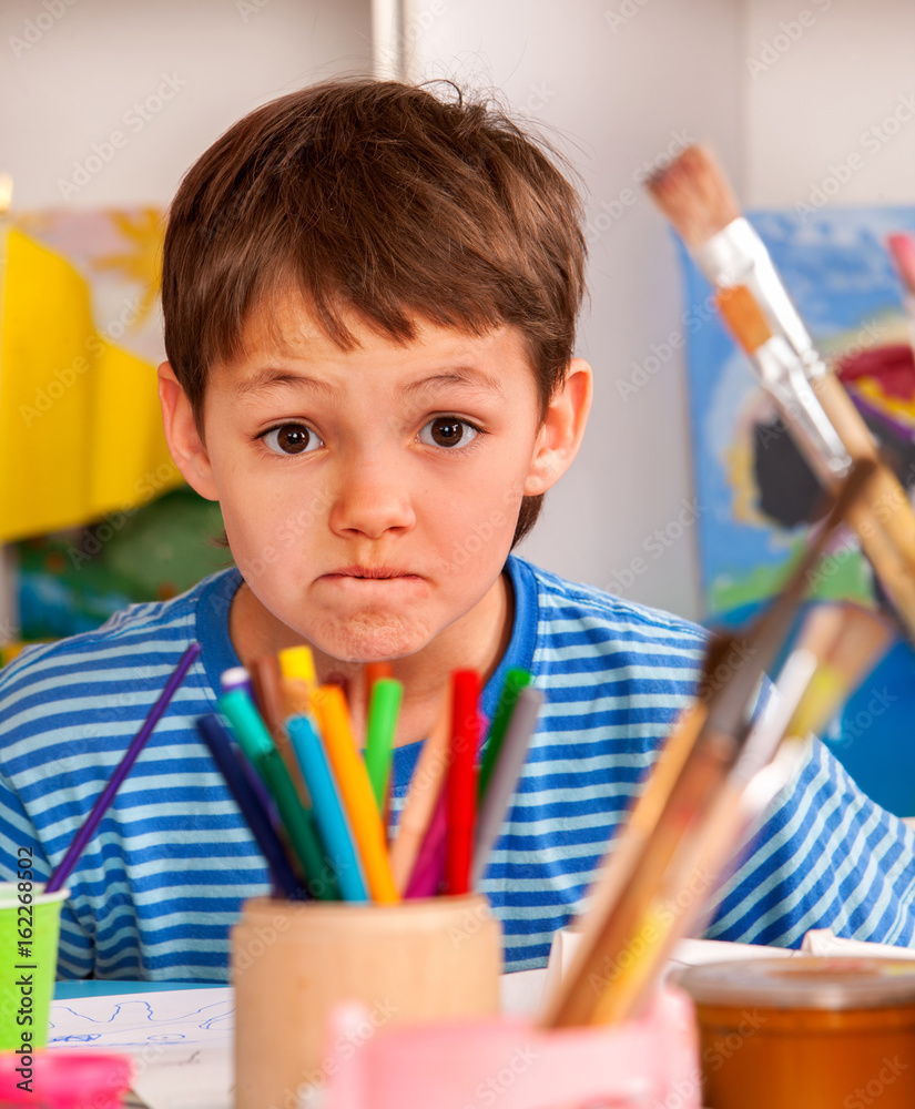 Foto de Small student boy painting in art school class. Child bad luck ...