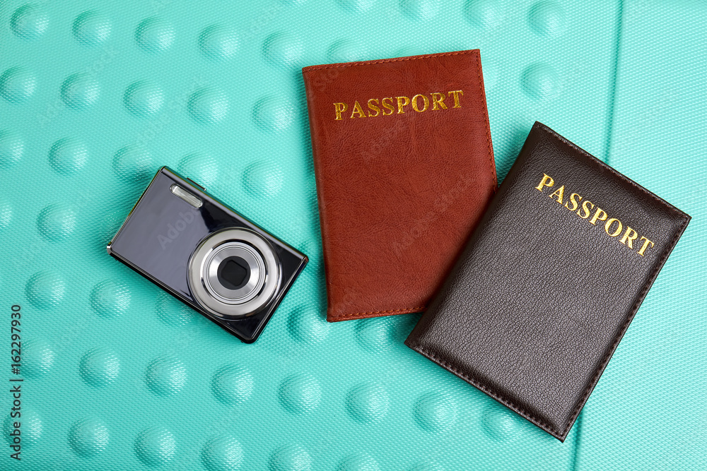 Camera, passports on textured background. Objects for tour abroad ...