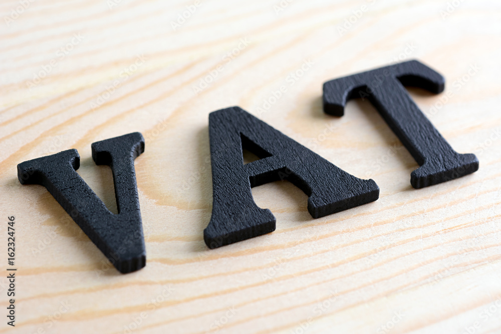 VAT letters (stand for Value Added Tax) on wood background Stock Photo ...