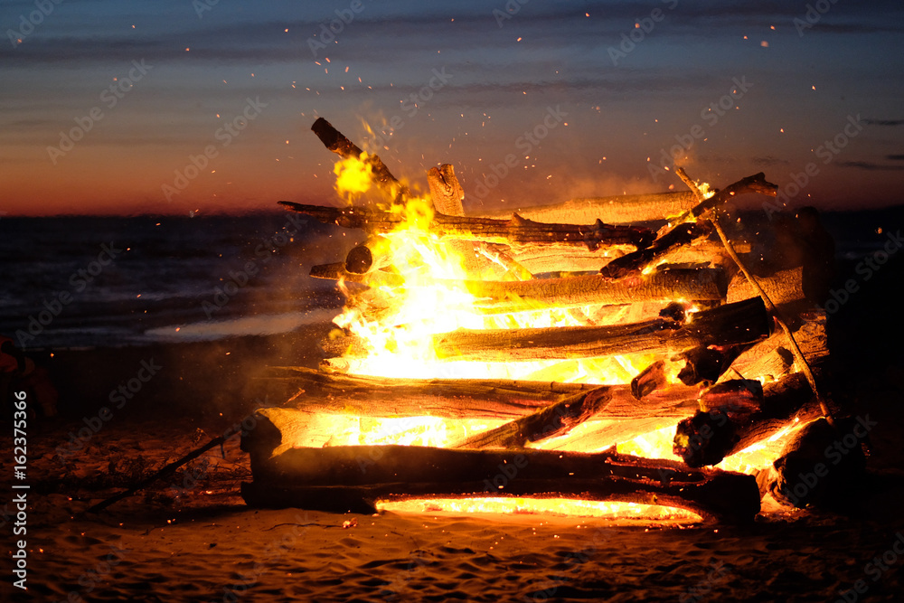 A large fire at the celebration of the summer solstice on the shore of ...