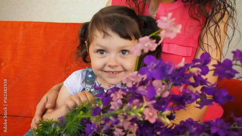 A child with flowers. Little girl with a bouquet of wildflowers. Stock ...