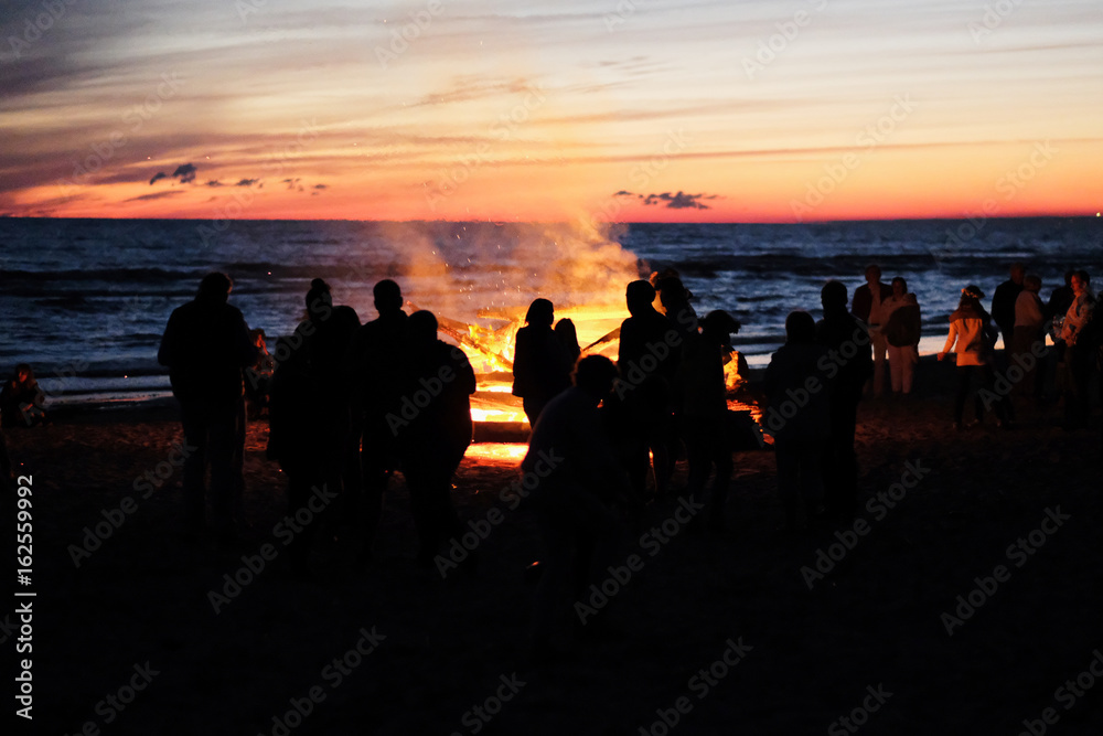 Young people at the celebration of the summer solstice on the shore of ...