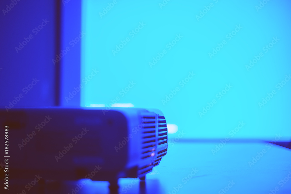 Screen with blue light from projector in the dark meeting room Stock ...