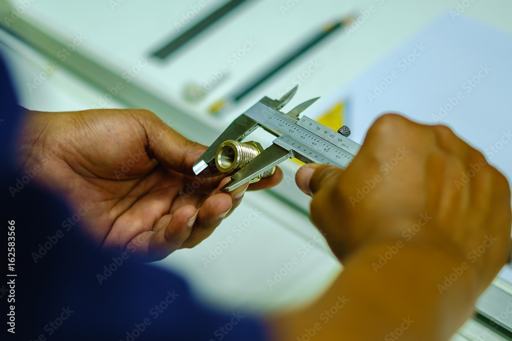 Man's hands using Vernier caliper to measure the object Stock Photo ...