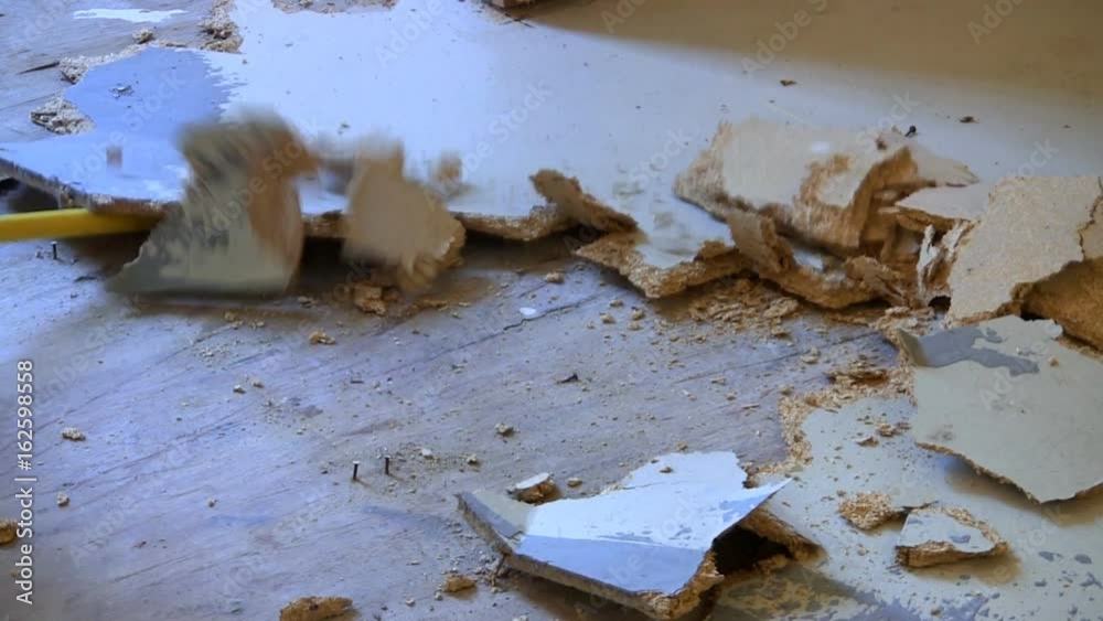 Ripping and prying a particle board sub floor with crowbar by homeowner ...