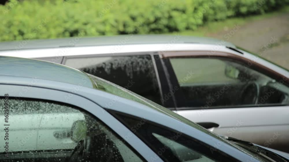 Rain falling on car side, roof and glass Stock Video | Adobe Stock