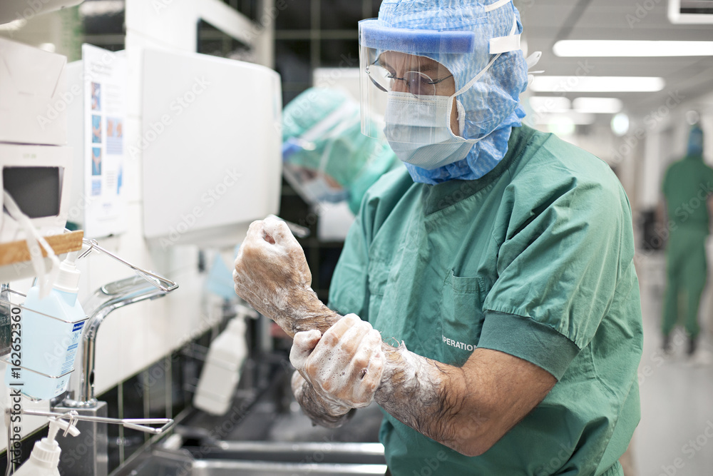 Surgeon washing hands and arms before surgery Stock Photo | Adobe Stock
