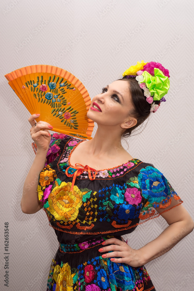 beautiful smiling mexican woman in traditional mexican dress with fan ...