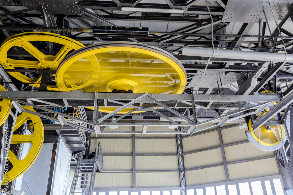 Yellow machinery wheels moving spinning with metal silver construction ...