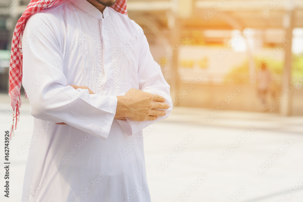 Muslim man wearing white traditional cloth praying and practicing the ...