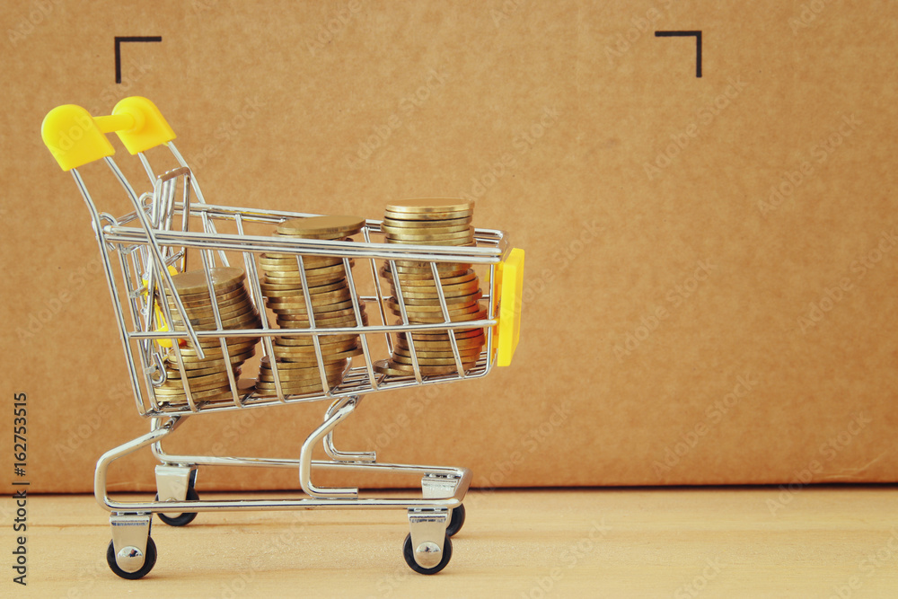 stack of coins in a trolley in frone of package box background Stock ...