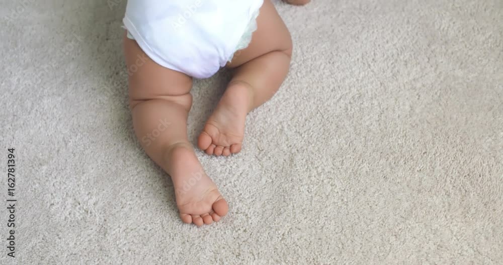 Baby Legs Crawling Away Above. shot from above of baby legs and diaper ...