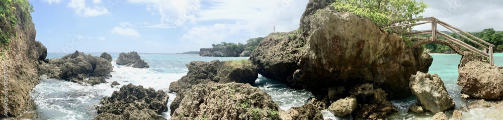 Secret romantic cove: Rocks, wooden bridge, tropical lush greenery ...