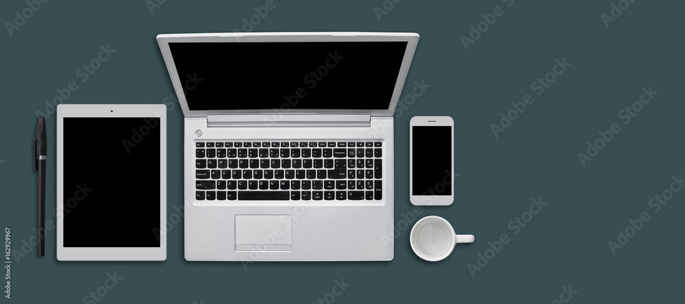 Office desk table with modern gadgets, cup and pen. Modern devices on ...
