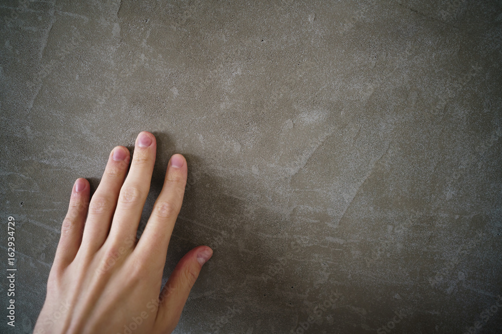 young man hand touching concrete wall Stock Photo | Adobe Stock