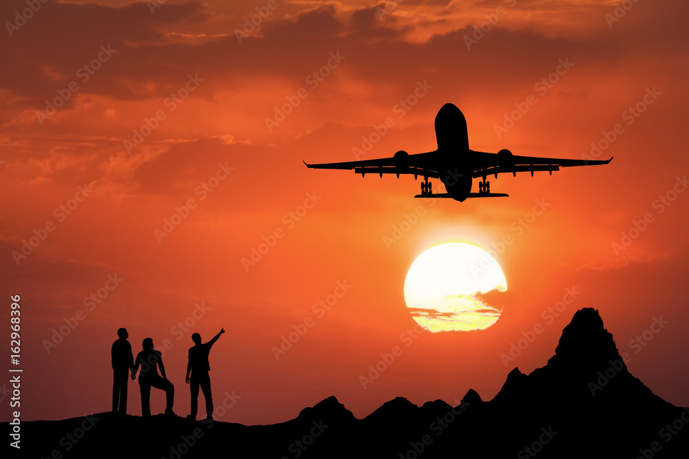 Landscape with silhouettes of standing people, passenger airplane ...