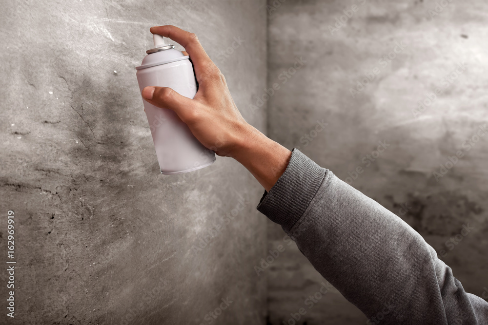 Hand holding a spray can Stock Photo | Adobe Stock