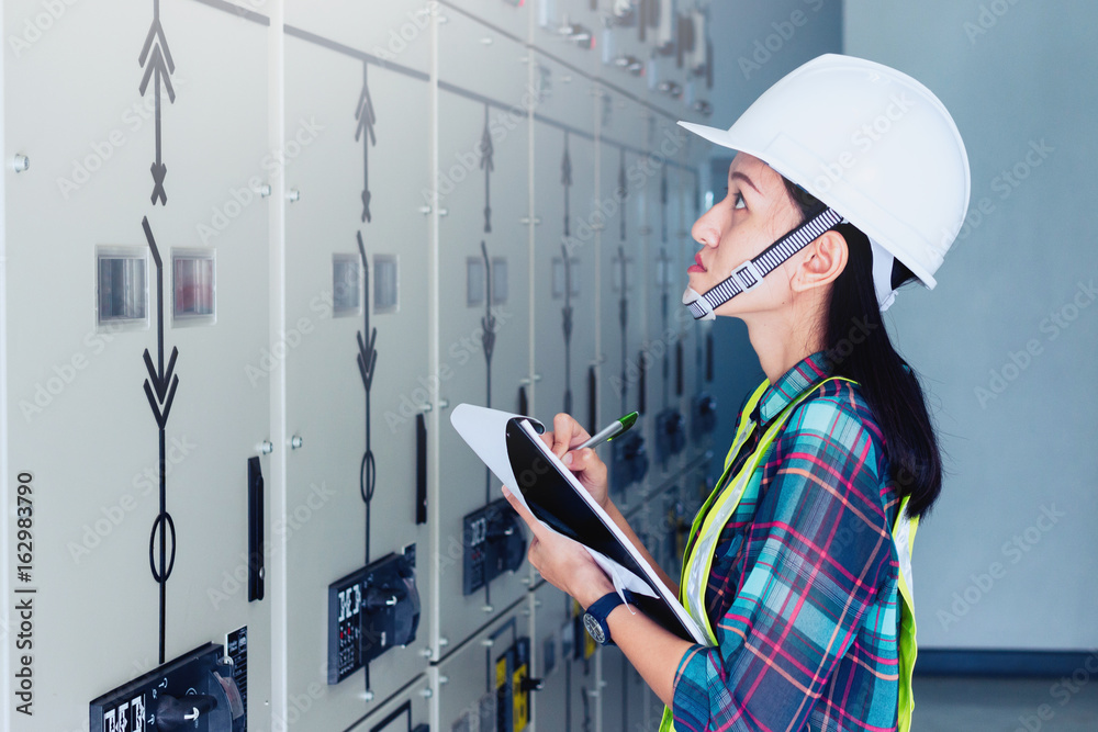 women engineer working on checking and maintenance electrical equipment ...