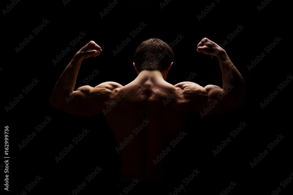 Strong muscular man showing his hands, shoulders, neck, bicep and back ...
