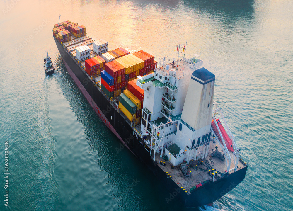aerial view of container ship vessel arrival to the main entrance of ...