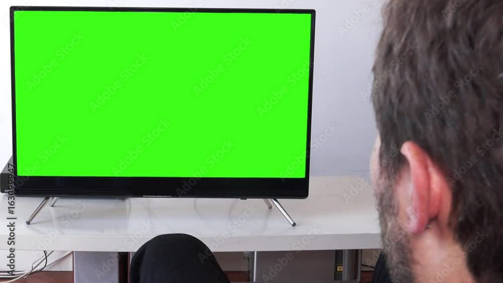 Man Watching TV Close Up Shot Behind Shoulders. Man watching television ...