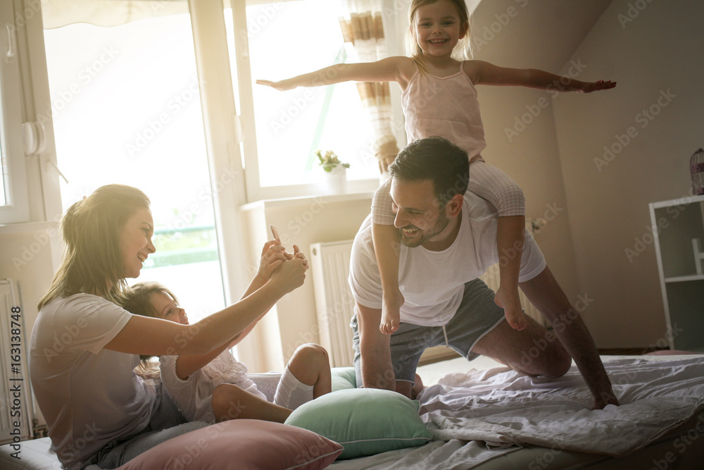 Happy family with two daughters at home. Stock Photo | Adobe Stock
