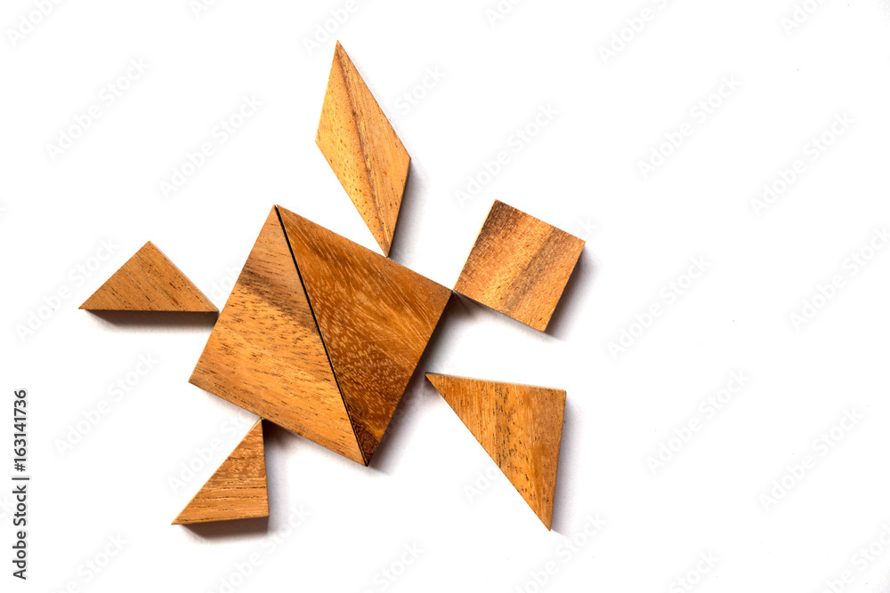 Wooden tangram puzzle in swimming turtle shape on white background ...