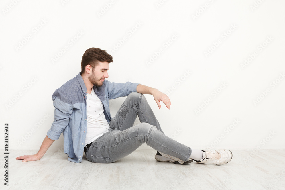 Relaxed man sitting on floor Stock Photo | Adobe Stock
