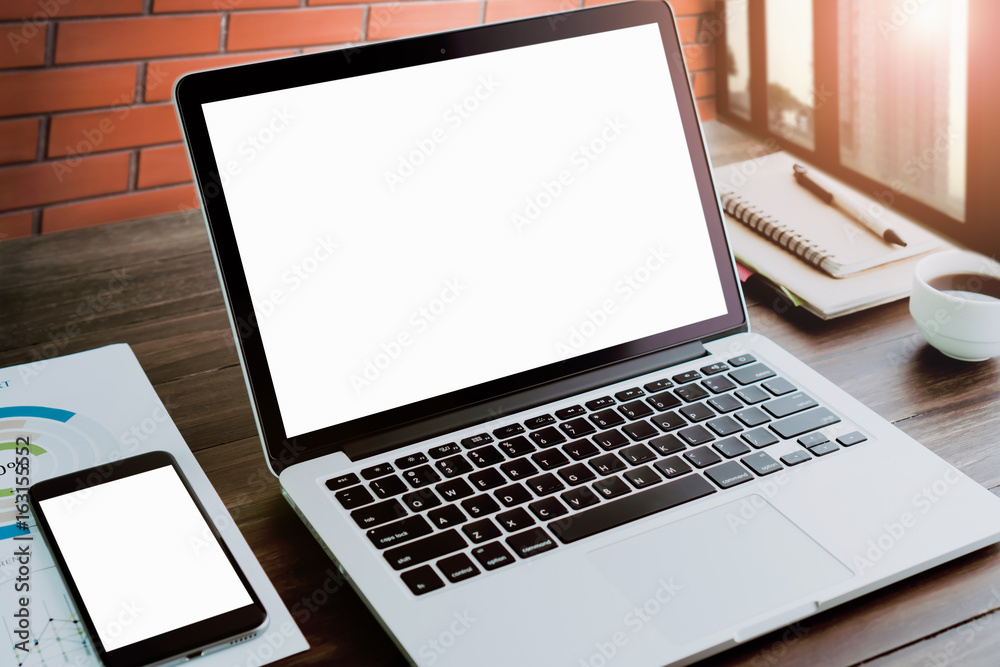 Laptop on table in office room, There is a brick red background, for ...