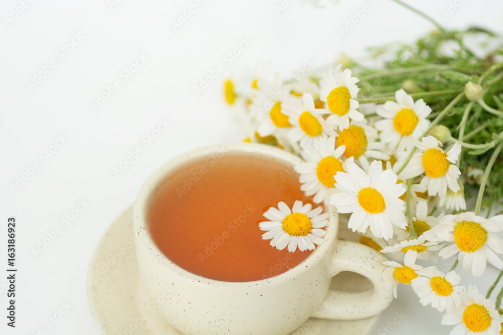 cup of herbal chamomile tea with fresh daisy flowers. doctor treatment ...