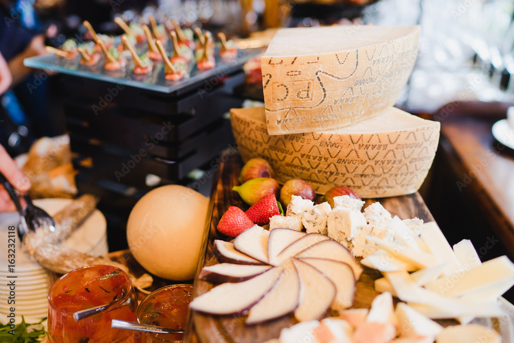 Catering banquet table at reception. Cheese delicatessen. Restaurant ...